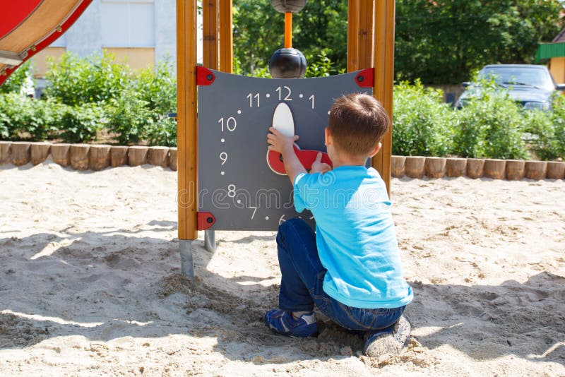 Little Boy Playing with Clock on Playground Stock Image - Image of ...