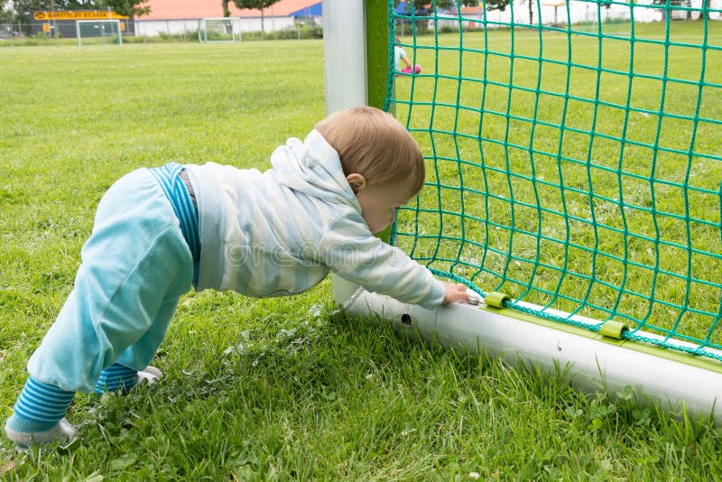 Little Boy Playing on the Football Field with Gates Stock Image - Image ...