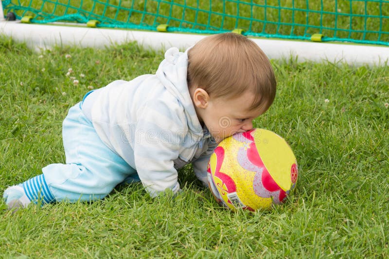 Little Boy Playing on the Football Field with Gates Stock Image - Image ...