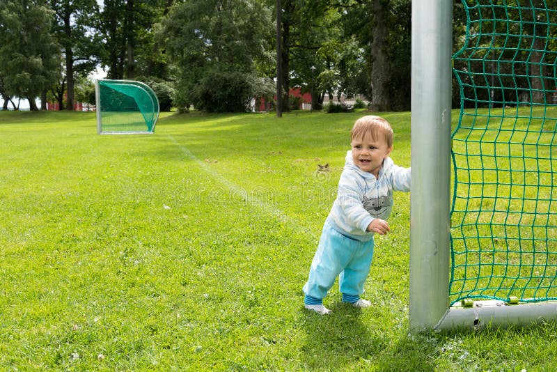 Little Boy Playing on the Football Field with Gates Stock Image - Image ...