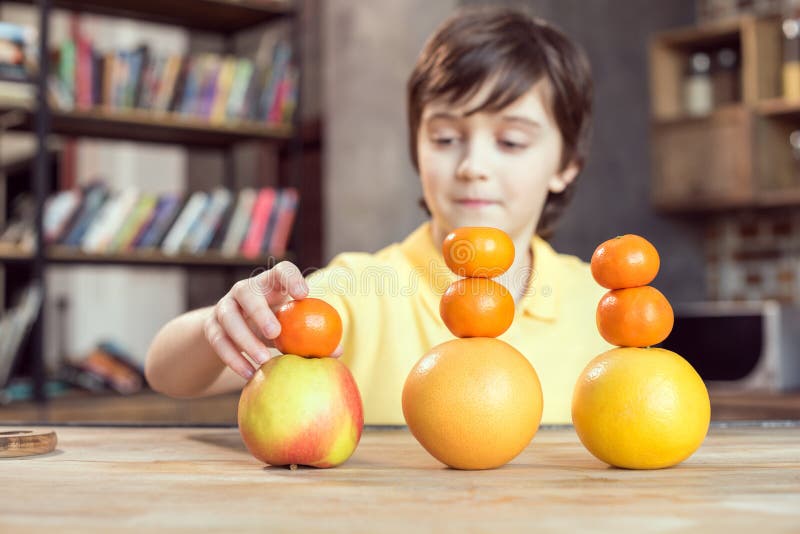 Little Boy Playing with Fresh Fruits on Table Stock Photo - Image of ...