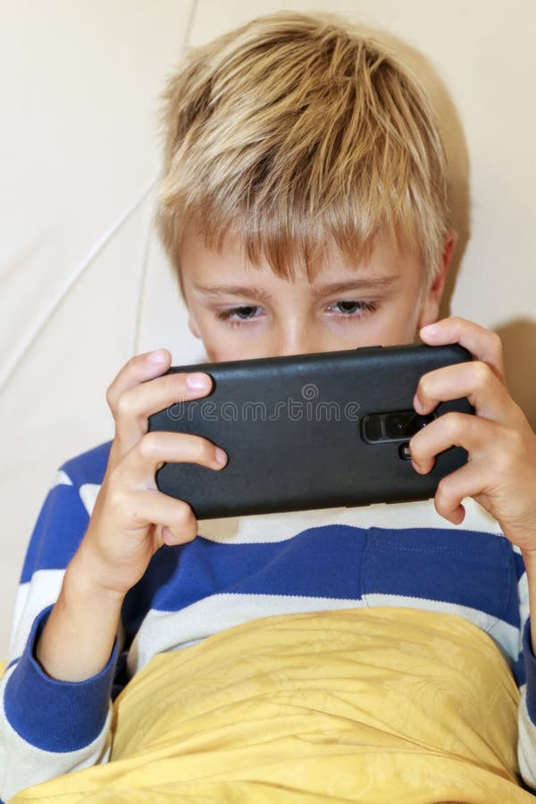 Little Boy Playing Game or Watching Something on Mobile Smart Phone ...