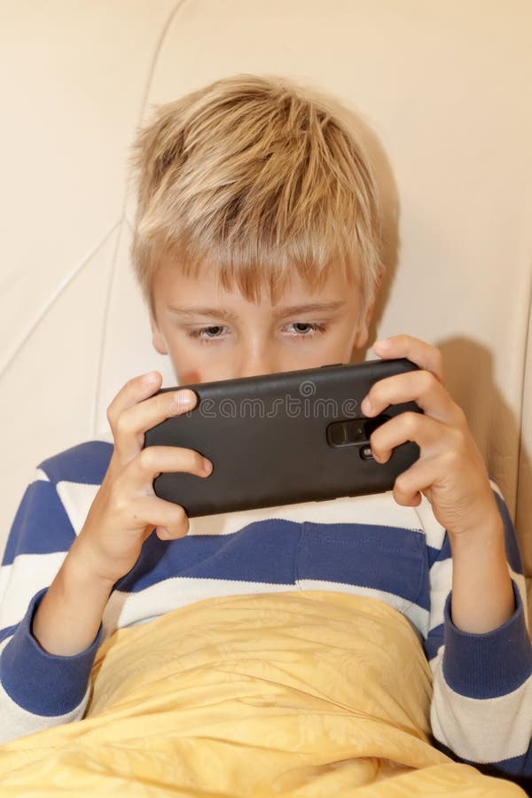 Little Boy Playing Game or Watching Something on Mobile Smart Phone ...