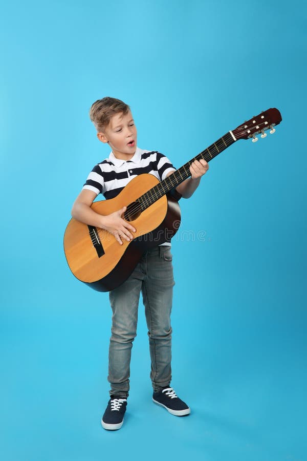 Little boy playing guitar stock image. Image of fulllength - 134069715
