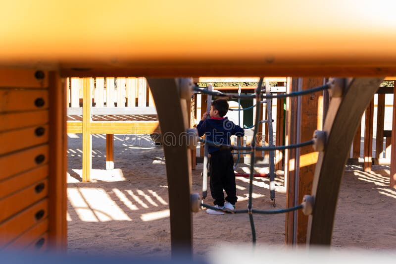 A Little Boy Playing, Having Fun Climbing the Structure at the Park ...