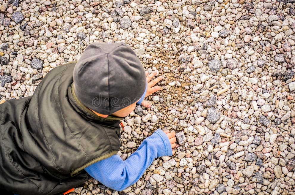 Little Boy Playing with Lying on the Pebbles in the Countryside Stock ...