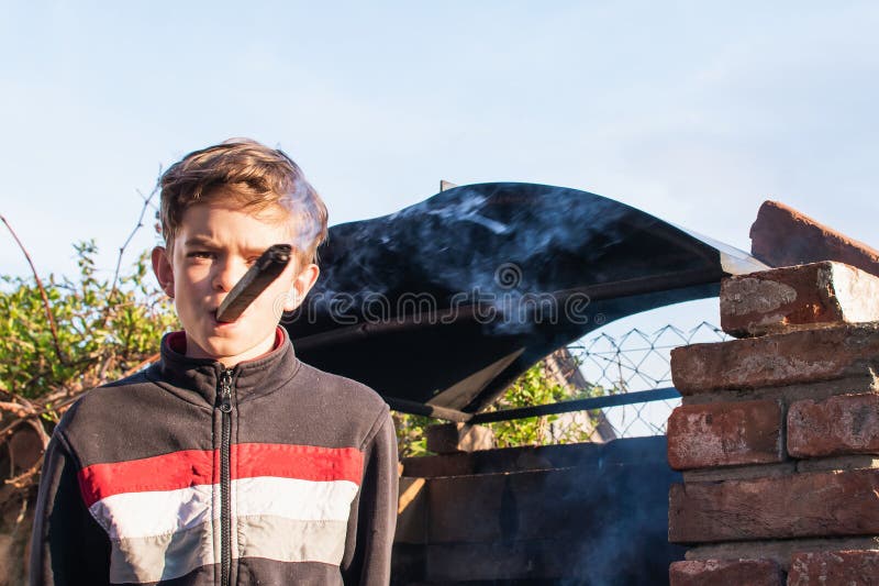 A Little Boy is Playing Near the Campfire Stock Image - Image of ...