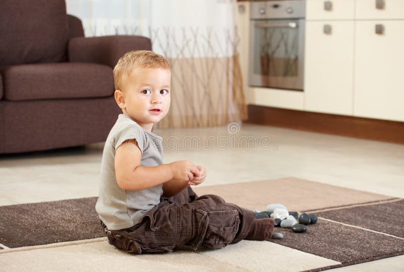 Little Boy Playing with Pebbles Stock Image - Image of child ...