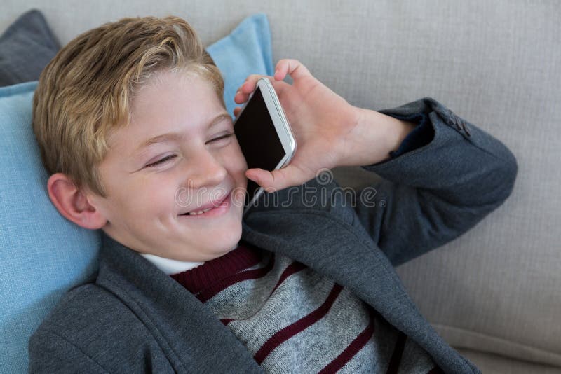 Little Boy Playing with Phone on Couch Stock Image - Image of lying ...