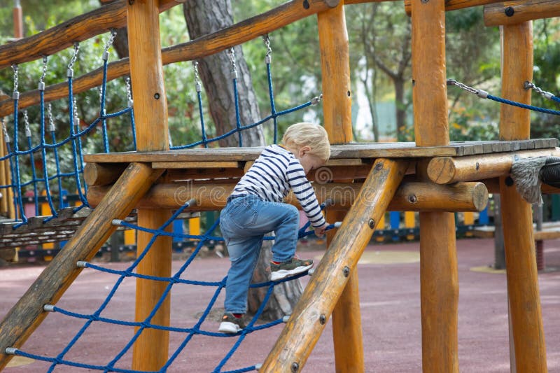 Little Boy Playing on the Playground Stock Image - Image of beautiful ...