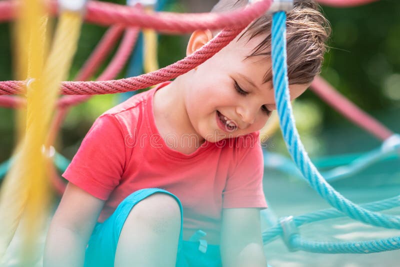 Little Boy Playing in the Rope Net on the Playground Stock Image ...
