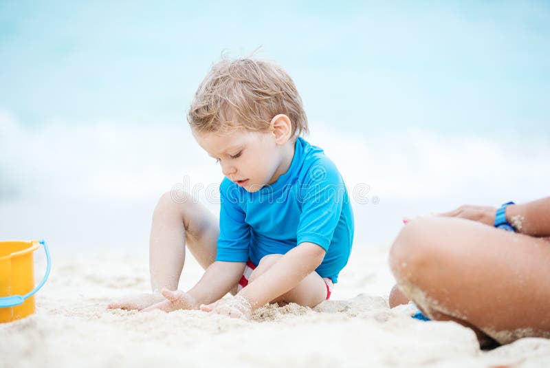 Little Boy Playing with Sand on the Beach Stock Photo - Image of little ...