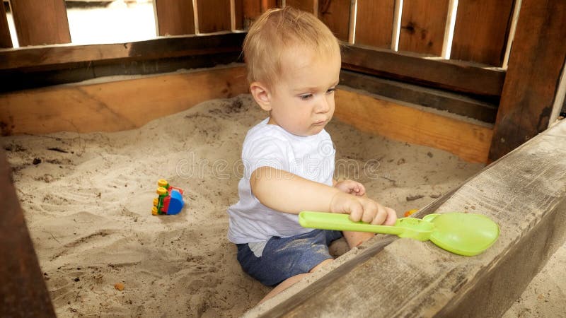 Little Boy Playing in Sandpit with Plastic Toys and Digging Sand Stock ...