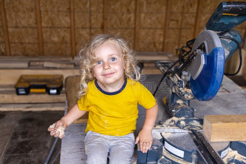 Little Boy Playing with Sawdust in a Workshop Stock Image - Image of ...