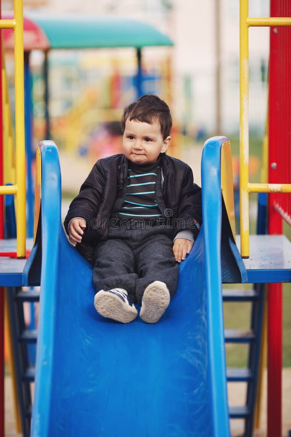 Little Boy Playing on Slide Stock Photo - Image of slide, male: 85243562