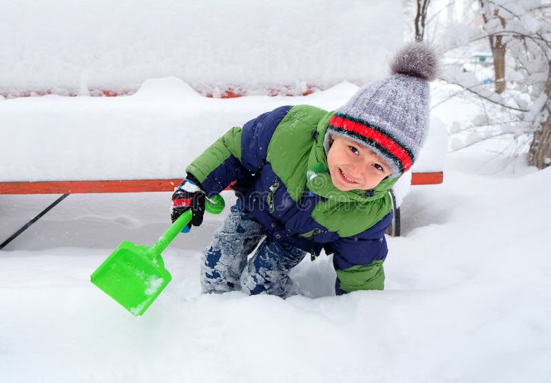 Little Boy Playing in the Snow on a Winter Day Stock Image - Image of ...