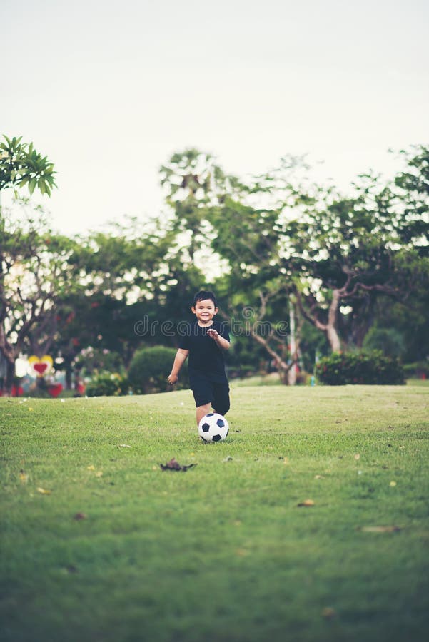 Little Boy Playing Football Stock Photo - Image of soccer, kick: 163997372