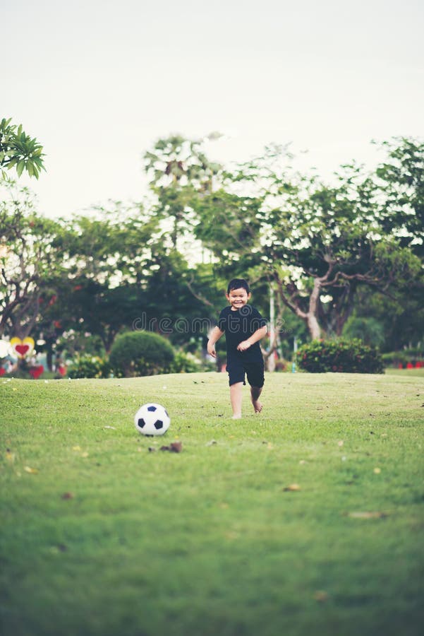 Little Boy Playing Football Stock Photo - Image of shooting, running ...
