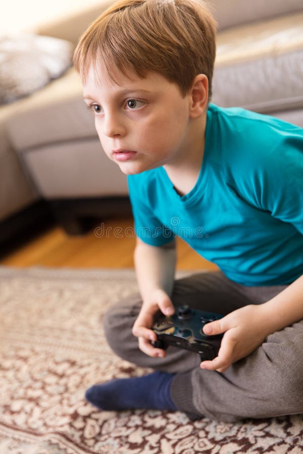 Boy playing video games stock photo. Image of concentrated - 245506096