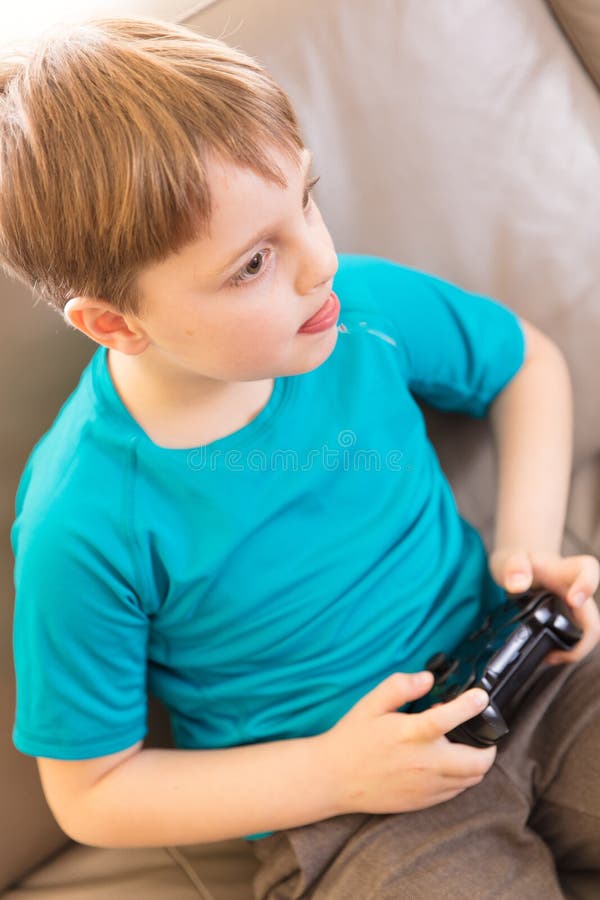 Boy playing video games stock photo. Image of sitting - 245506300