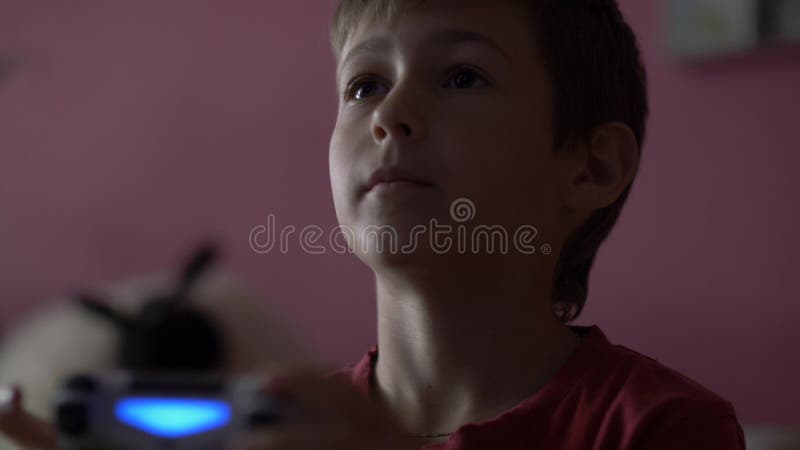 Little Boy Playing Some Video Games at Home Using a Controller, Making ...