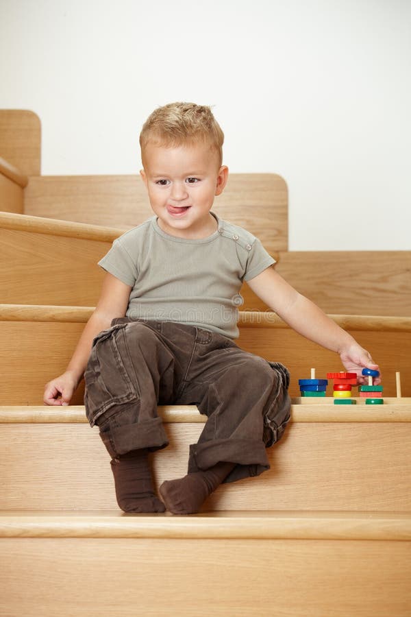 Little Boy Playing on Stairs Stock Photo - Image of happy, color: 20941170