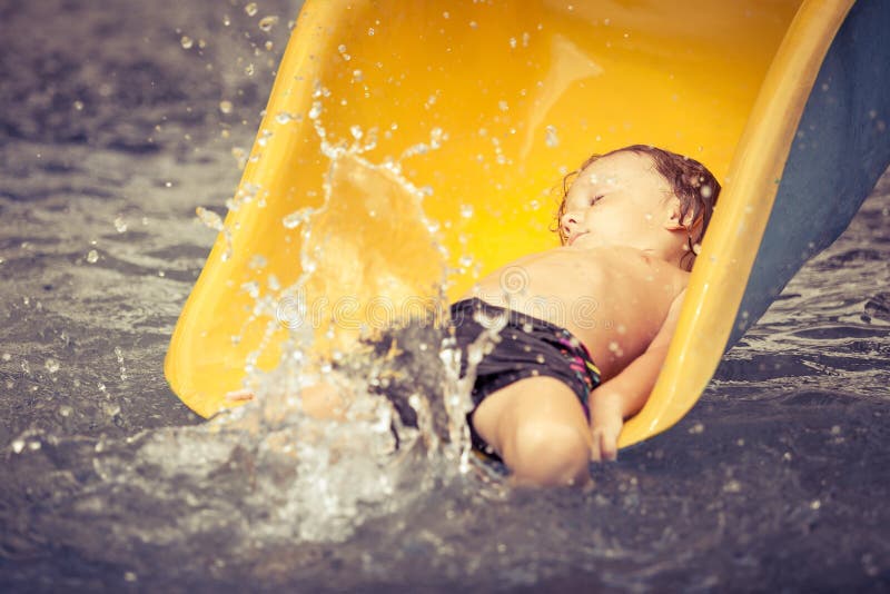 Little Boy Playing in the Swimming Pool on Slide Stock Image - Image of ...