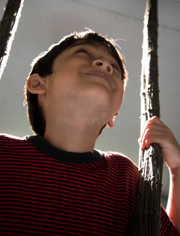 Little Boy Playing Swing Indoor Rim Light Stock Image - Image of ...