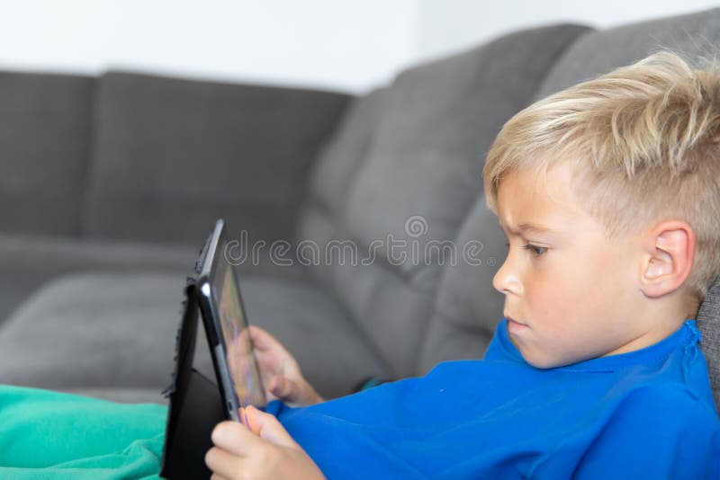 Little Boy Playing on Tablet Stock Photo - Image of cute, lying: 162120786