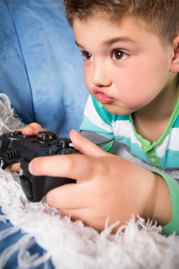 Little Boy Playing Video Games Stock Photo - Image of emotion, playful ...