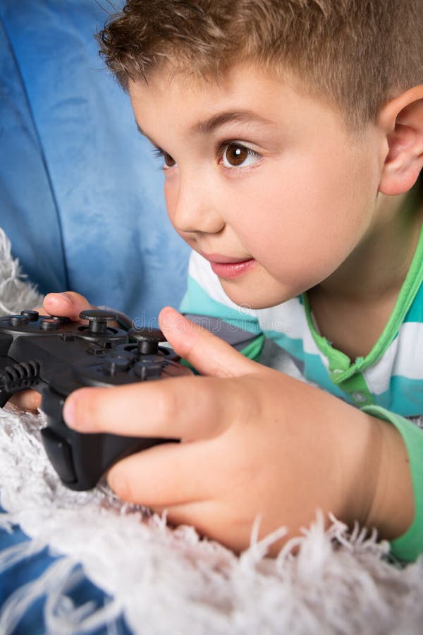 Little Boy Playing Video Games Stock Image - Image of happy, portrait ...