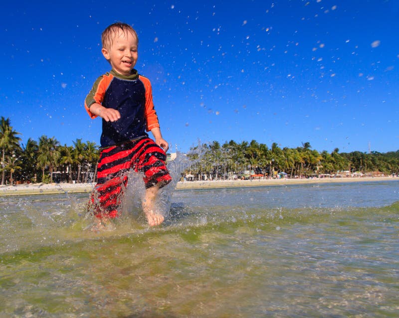 Little Boy Playing with Water on the Beach Stock Photo - Image of ...