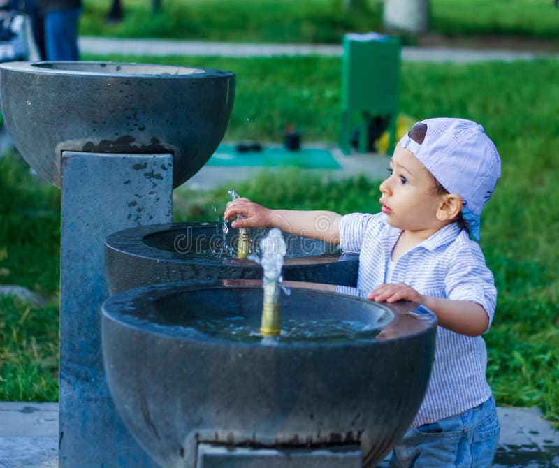 Little Boy Playing with Water in the Park Stock Photo - Image of picnic ...