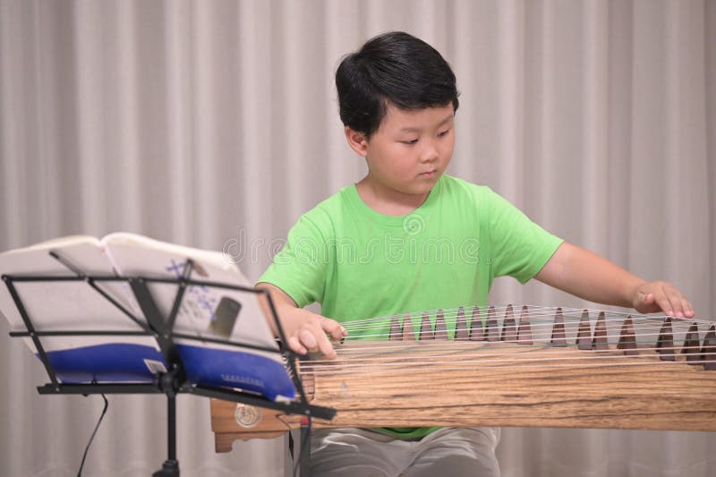 Little boy playing zither stock photo. Image of music - 281052870