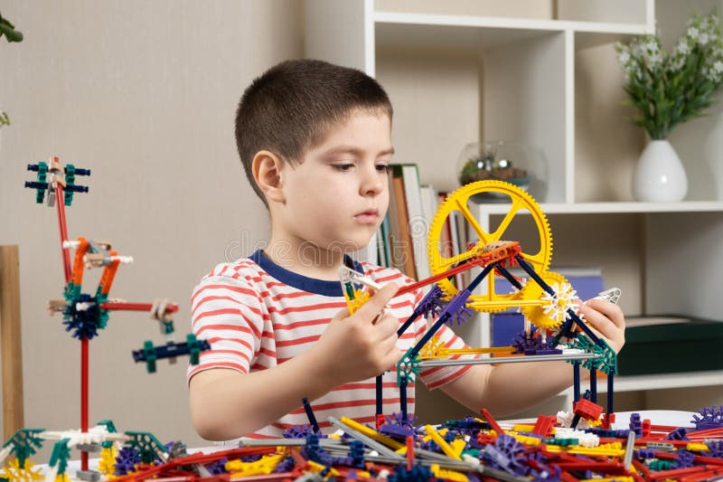A Little Boy Plays with a Constructor, Creating Figures from Gears and ...
