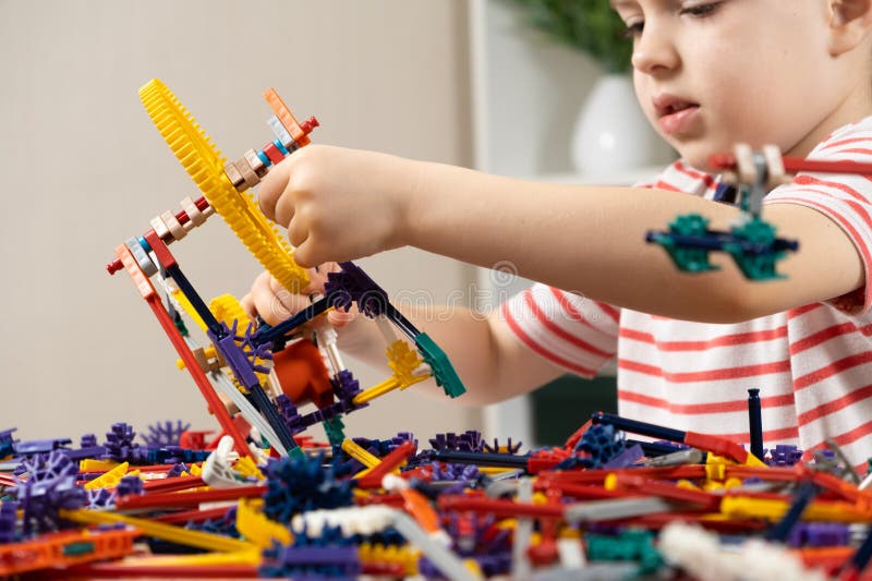 A Little Boy Plays with a Constructor, Creating Figures from Gears and ...