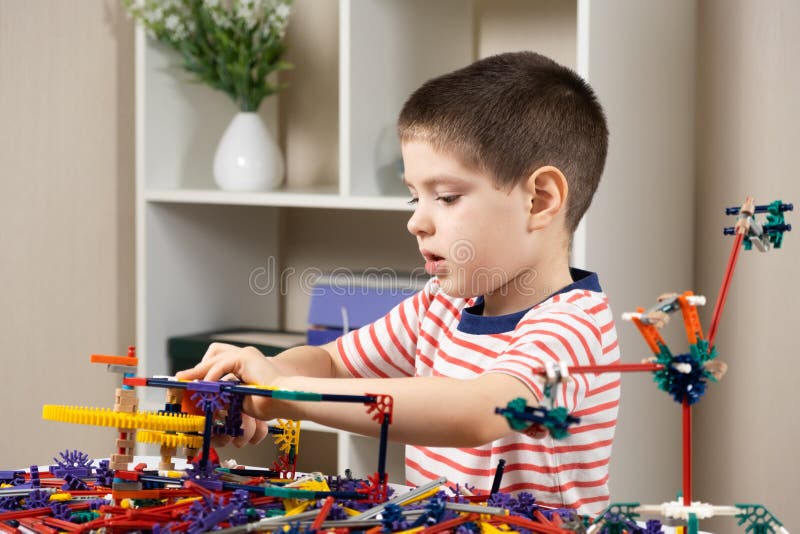 A Little Boy Plays with a Constructor, Creating Figures from Gears and ...