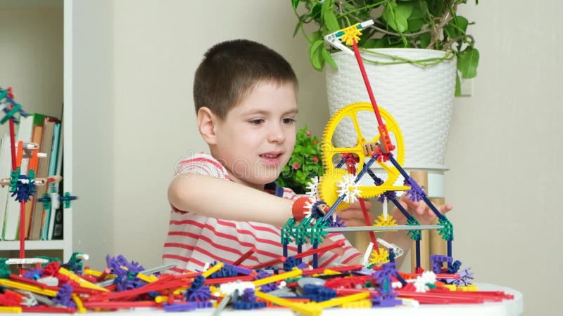 A Little Boy Plays with a Constructor, Creating Figures from Gears and ...