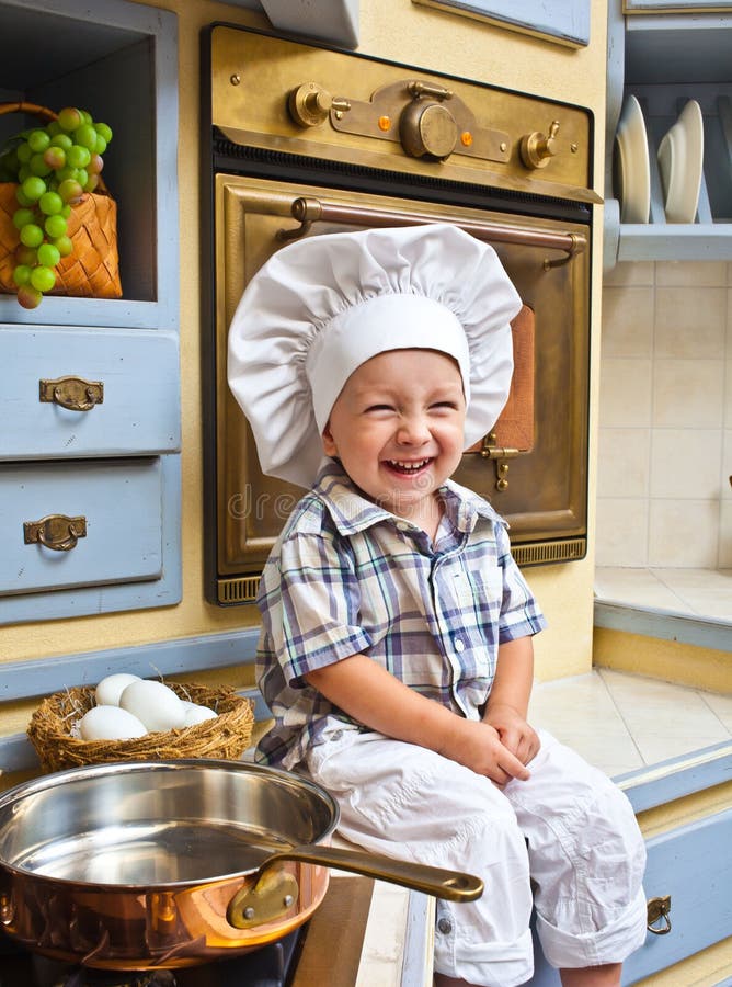 Little boy plays the cook stock image. Image of face - 39652695