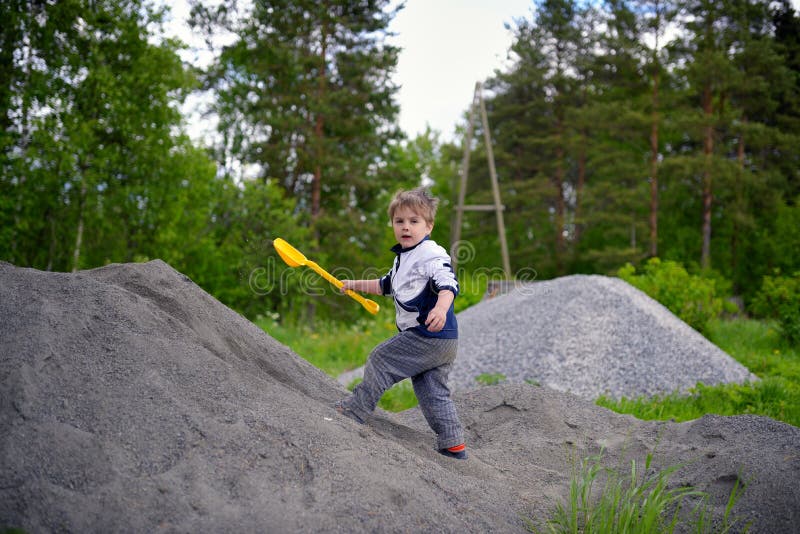 Little Boy Plays on Heap of Crushed Stone Stock Photo - Image of ...