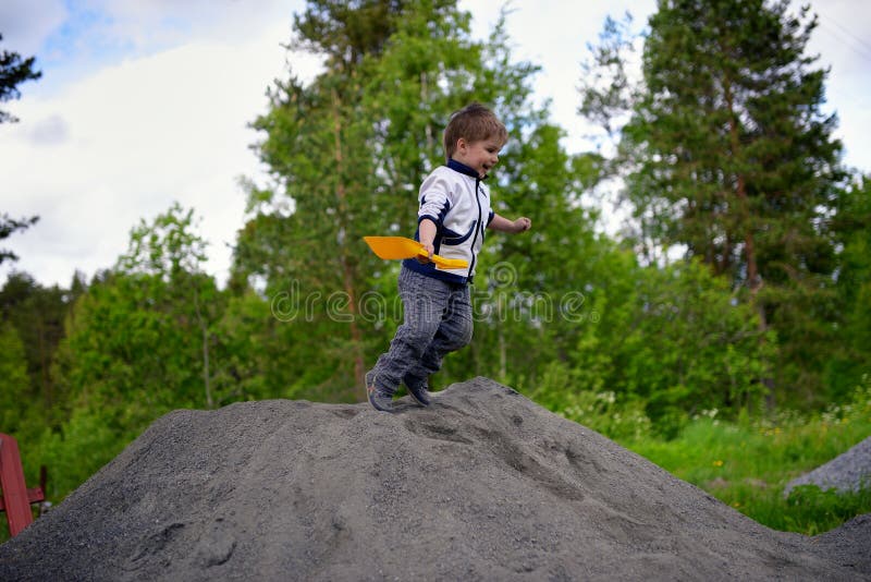 Little Boy Plays on Heap of Crushed Stone Stock Photo - Image of ...