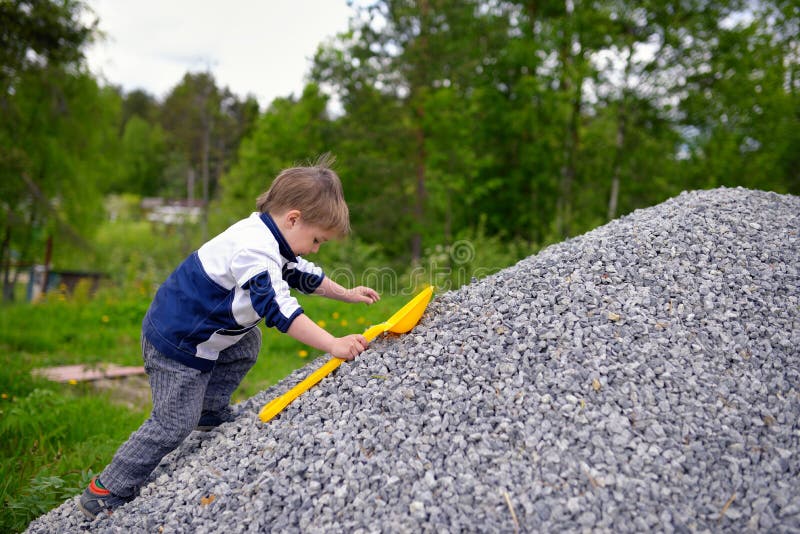 Little Boy Plays on Heap of Crushed Stone Stock Image - Image of ...
