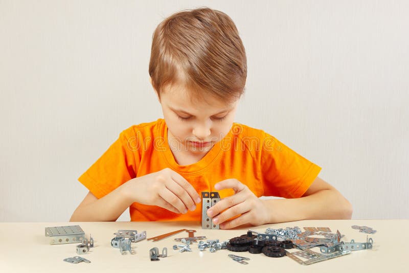 Little Boy Plays with Mechanical Constructor at Table Stock Image ...