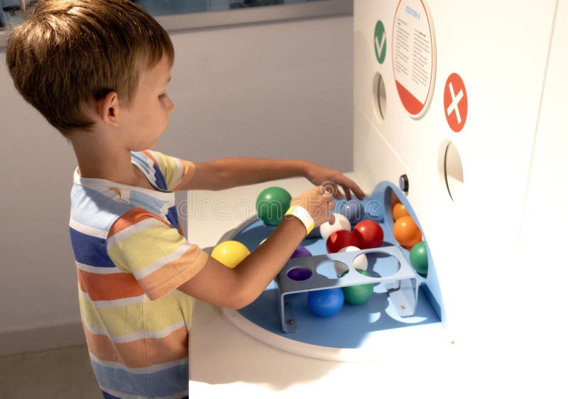 Little Boy Plays Puzzle with Colorful Balls. Science Museum. Problem ...