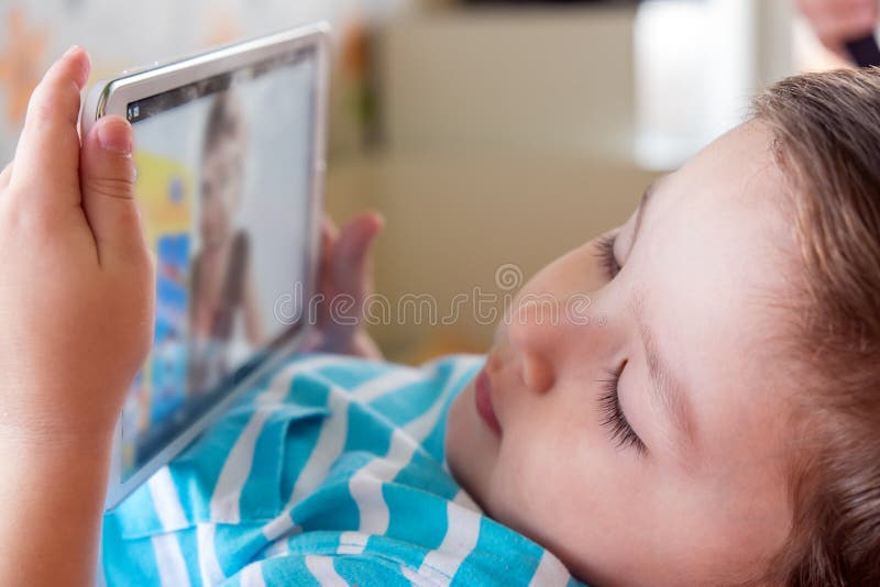 Little Boy Plays in the Smartphone. Game on the Phone Stock Photo ...