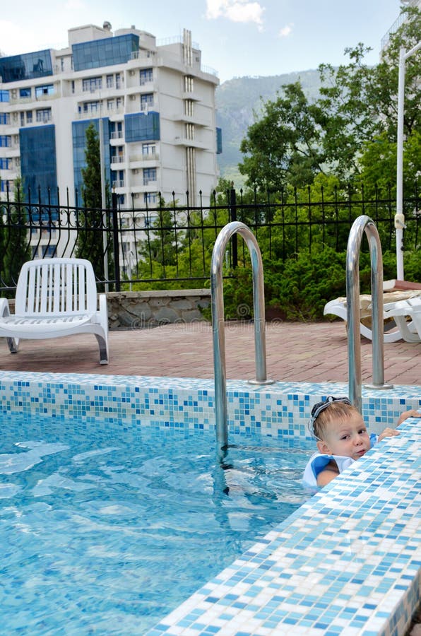 Little Boy in a Pool Hanging Onto the Edge Stock Photo - Image of ...