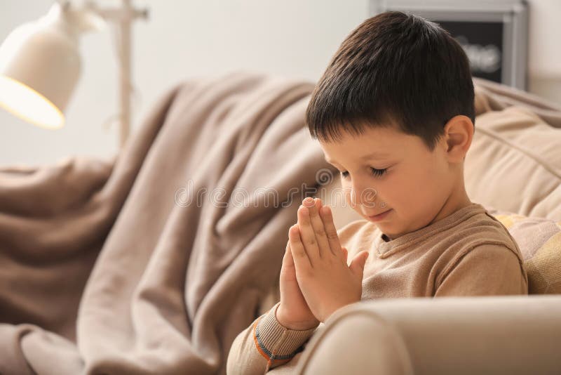Little boy praying at home stock photo. Image of innocence - 151275850