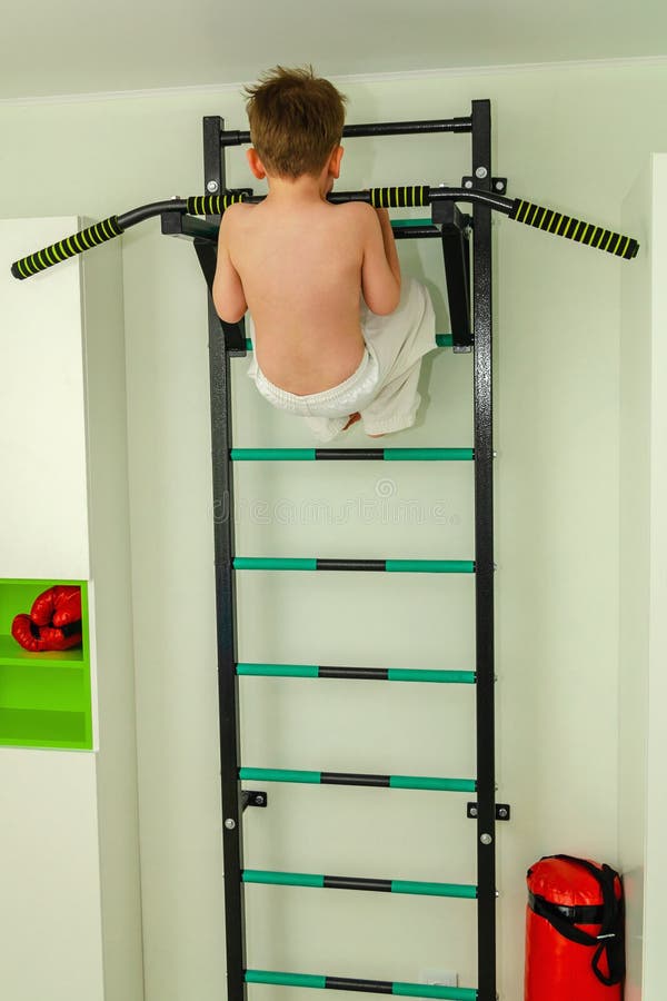 Little Boy of Preschool Age Does Morning Exercises on a Home Horizontal ...