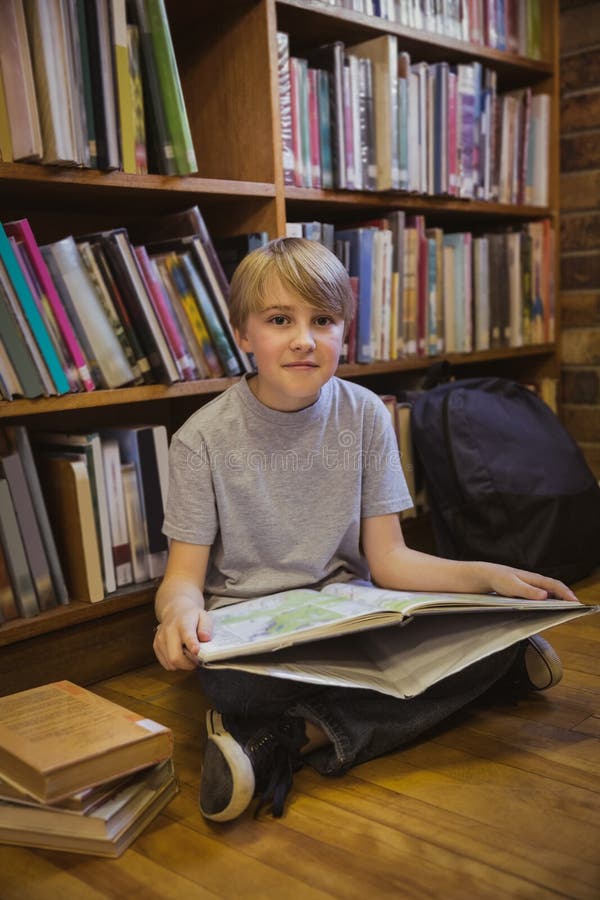Little Boy Reading on Library Floor Stock Photo - Image of smiling ...
