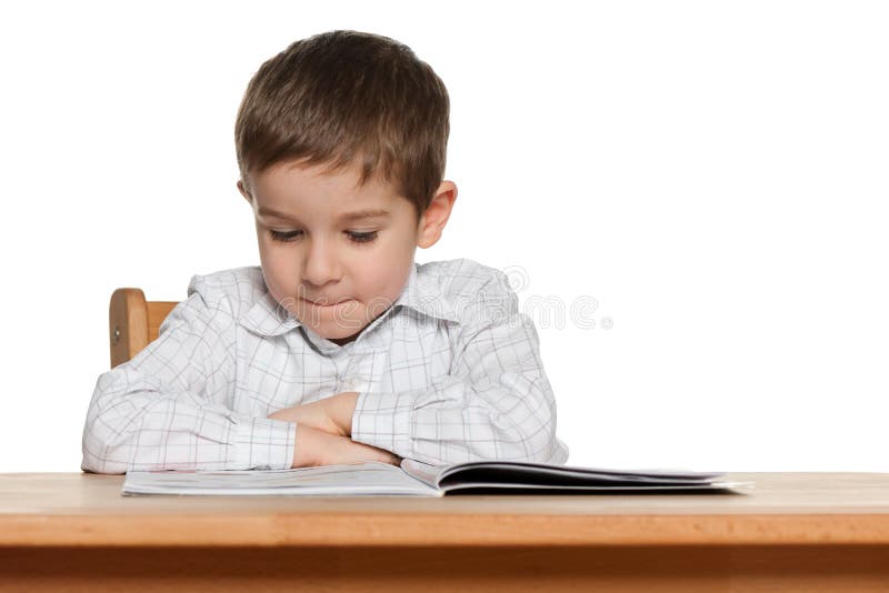 Little Boy Reads at the Desk Stock Photo - Image of children, learn ... Little Boy Reads at the Desk Stock Photo - Image of children, learn ...
